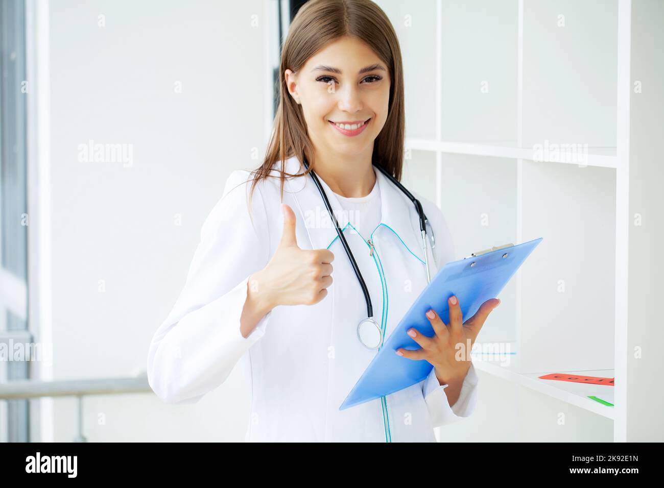 Female Doctor In Surgery Reading Patient Notes Stock Photo - Alamy