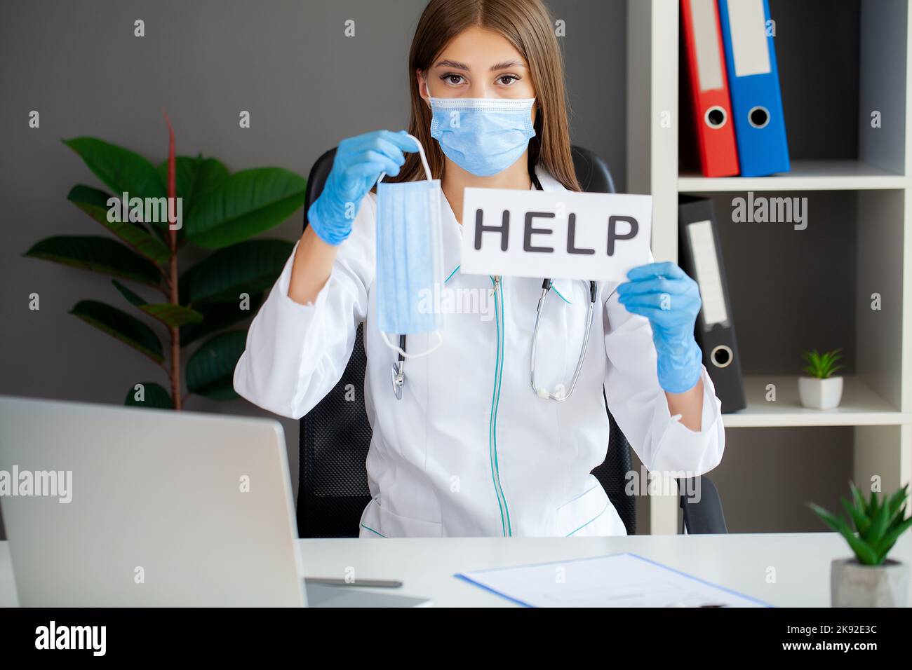 Doctor or nurse showing help sign in office Stock Photo - Alamy
