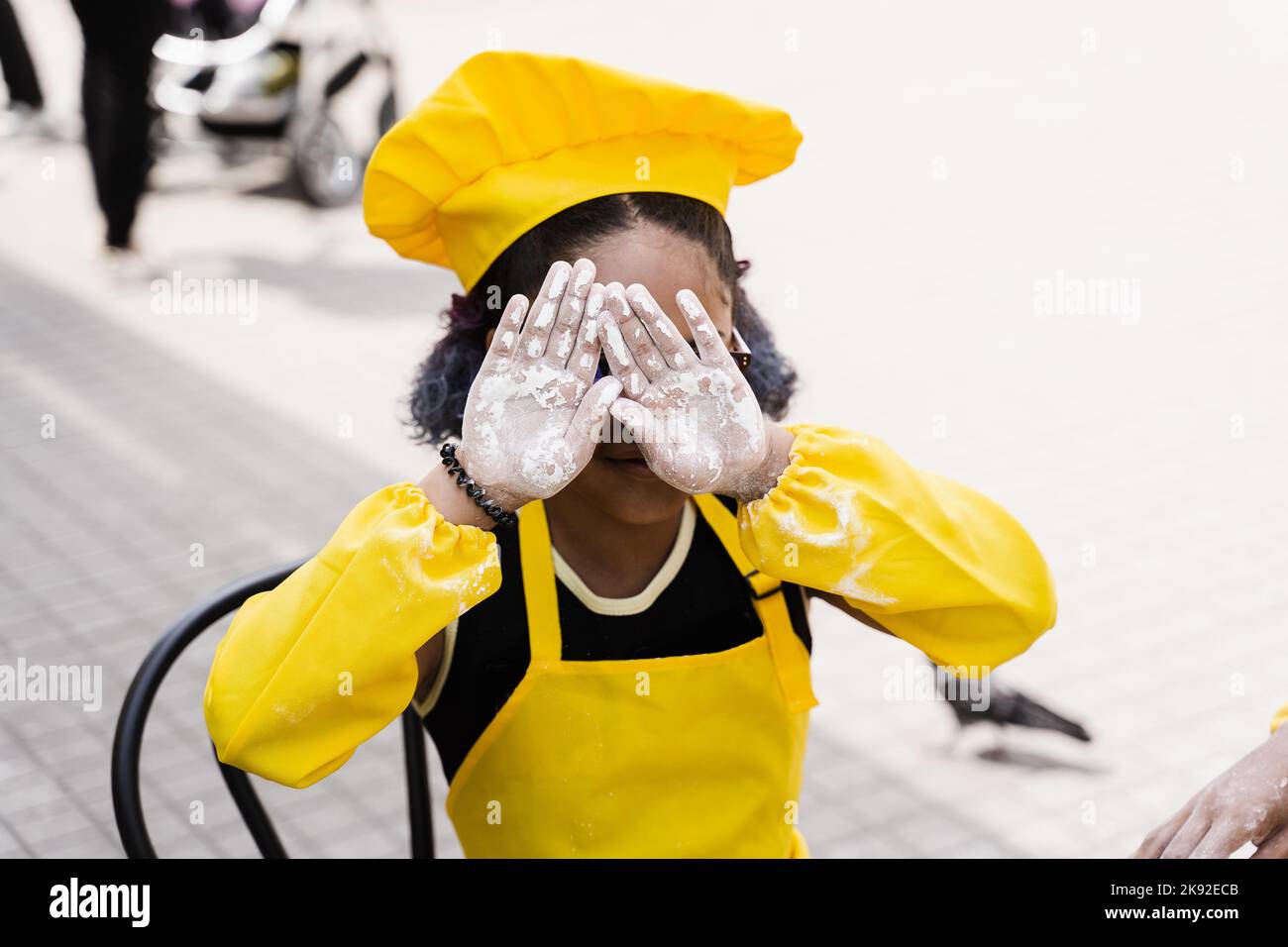 Black african cook child girl showing hands with flour and close her ...
