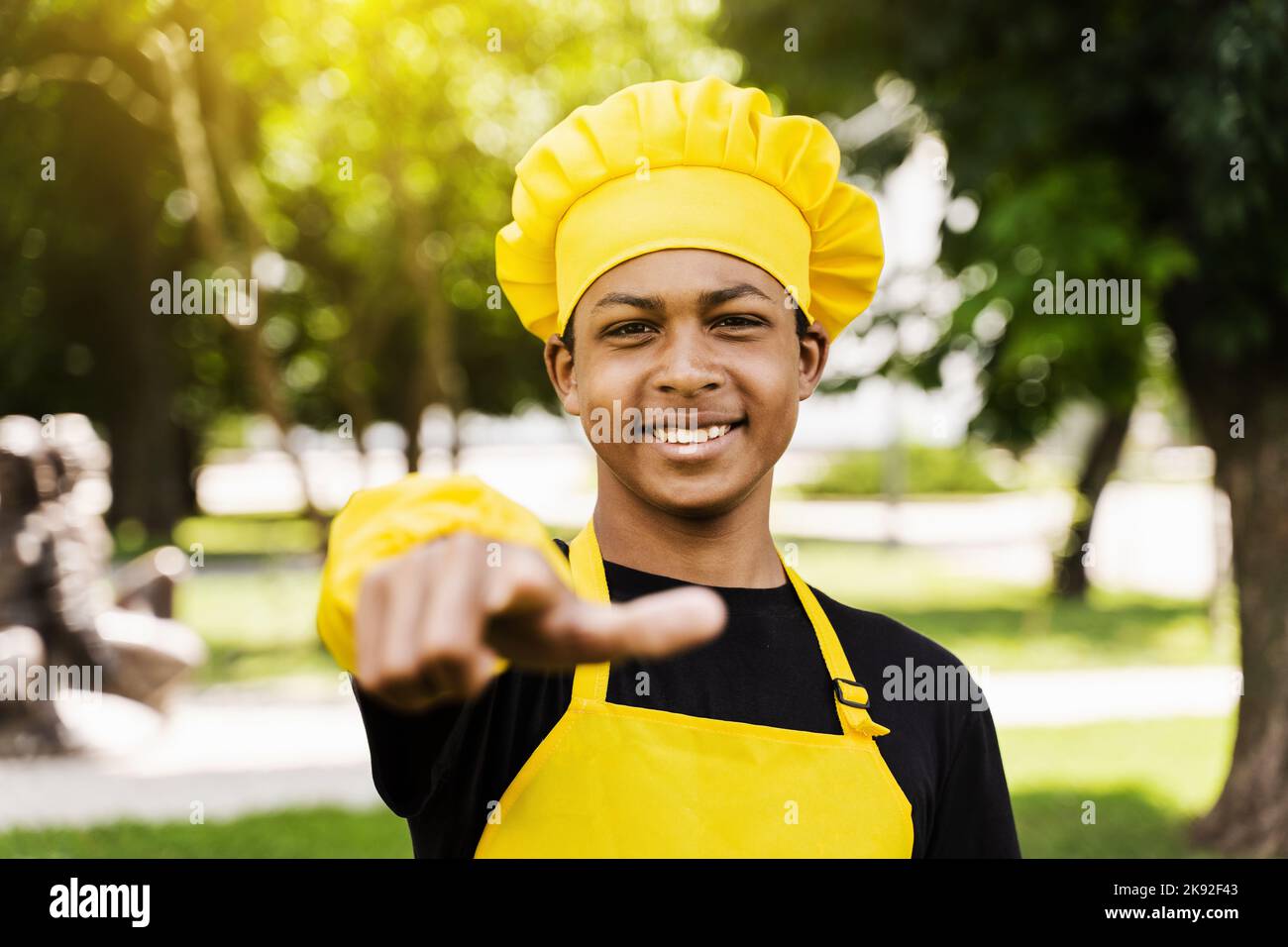 Handsome african teenager cook points to you. Black child cook in chefs ...