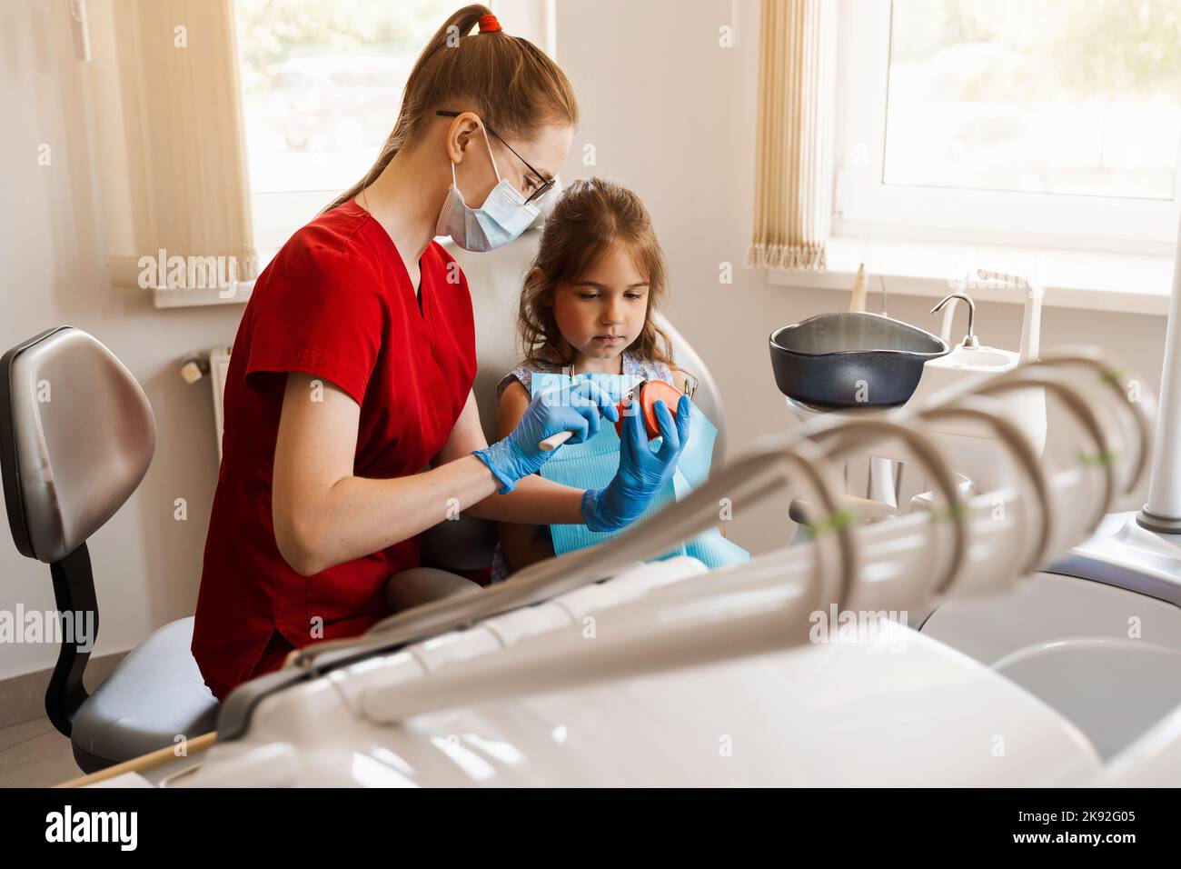 Dentist shows child how to properly use toothbrush for brush teeth. Jaw ...
