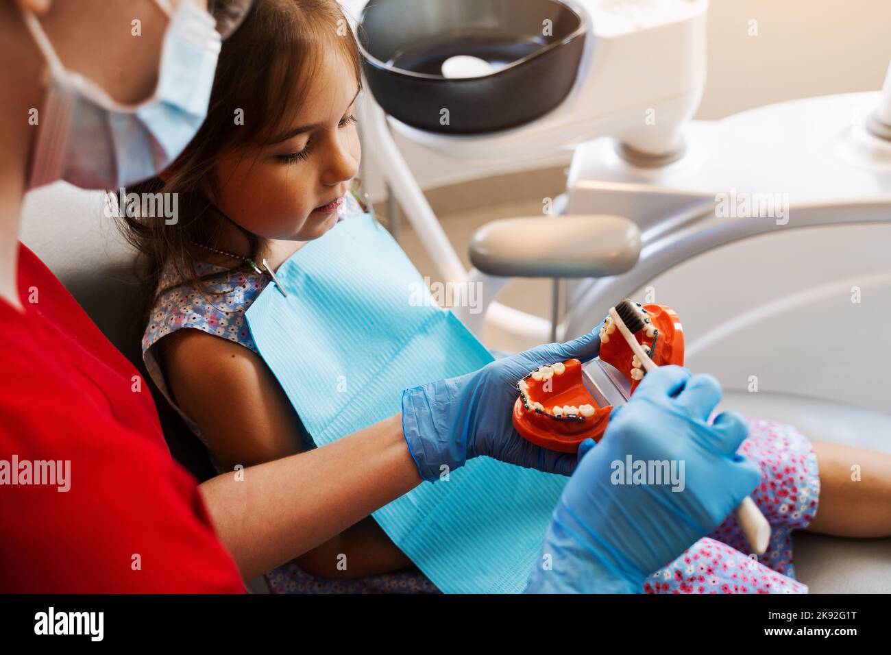 Dentist shows child how to properly use toothbrush for brush teeth. Jaw ...