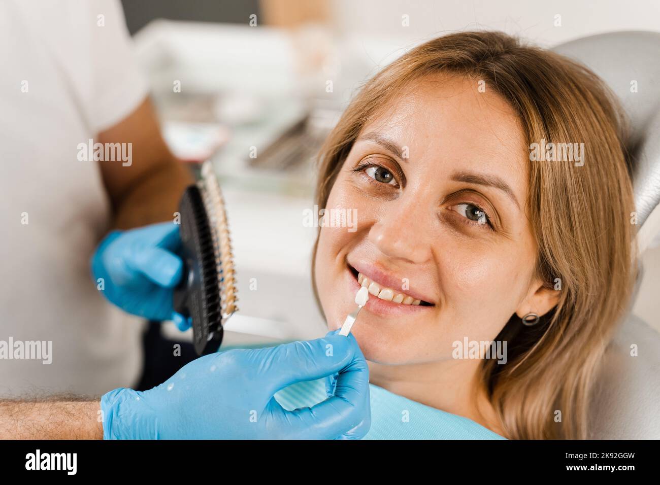 Teeth color shades guide close-up with woman patient. Tooth whitening ...