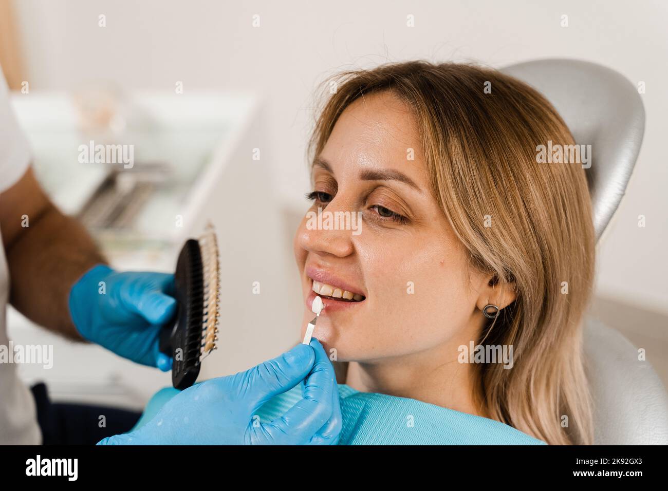 Teeth color shades guide close-up with woman patient. Tooth whitening ...