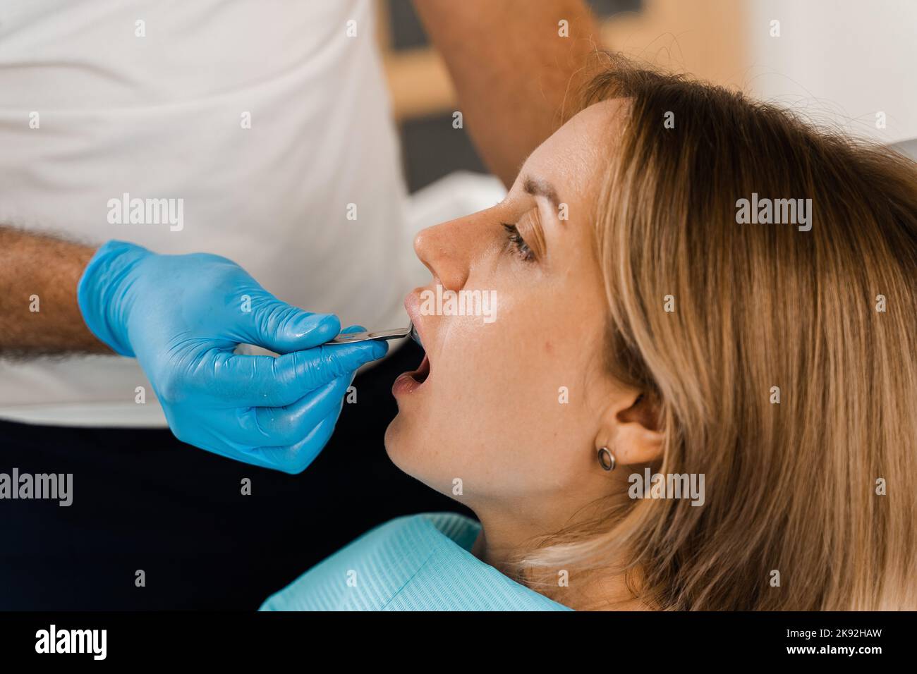 Doctor inserts impression tray and making cast of teeth to patient in ...