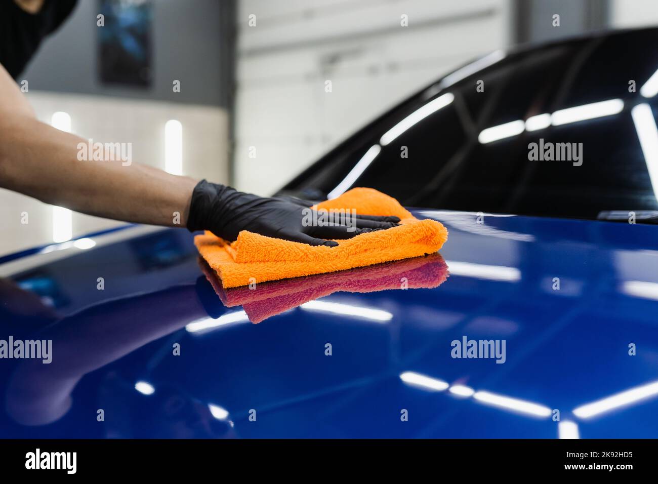 Hand car drying with microfiber in detailing auto service. Cleaner ...