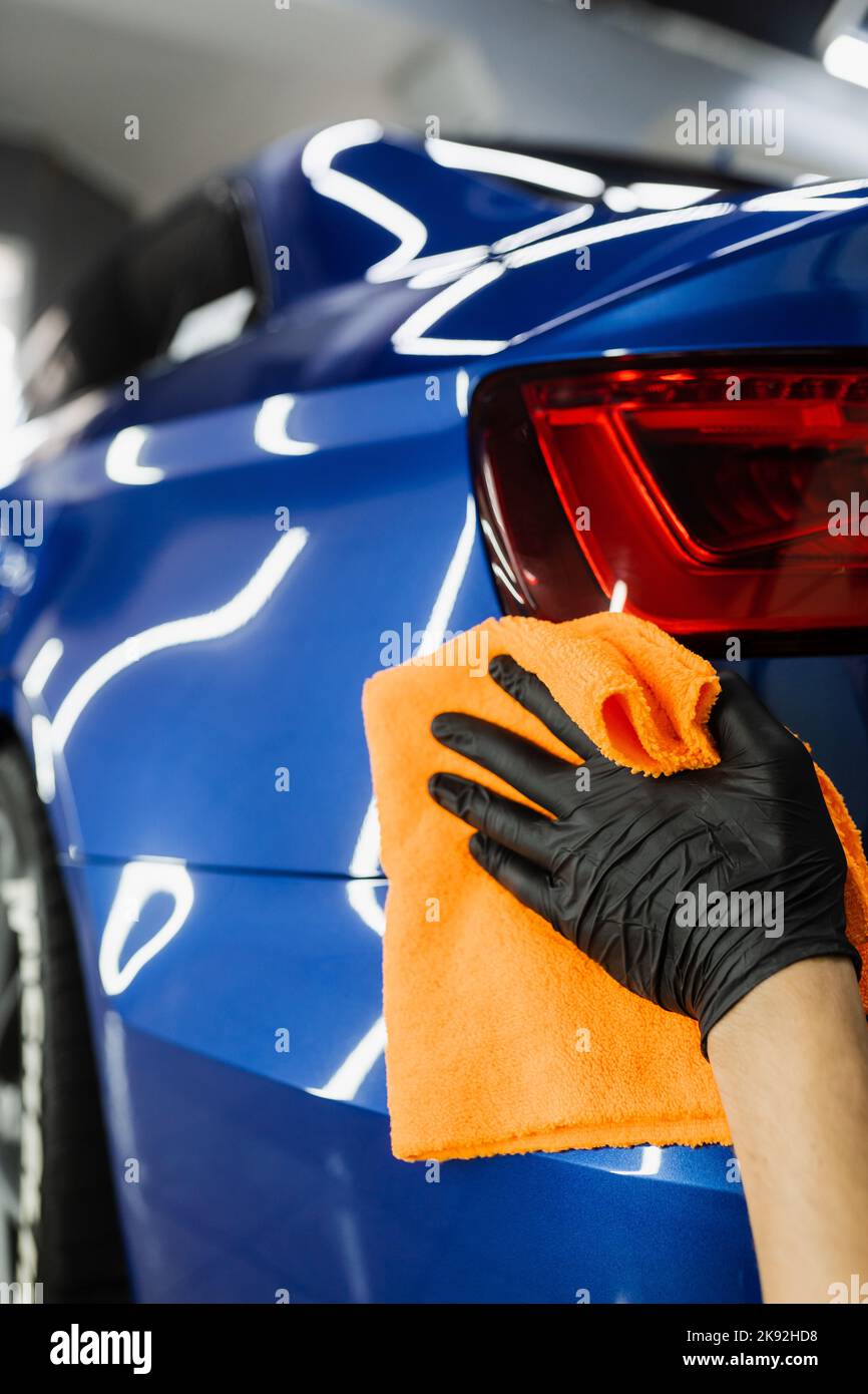 Hand car drying with microfiber in detailing auto service. Cleaner ...