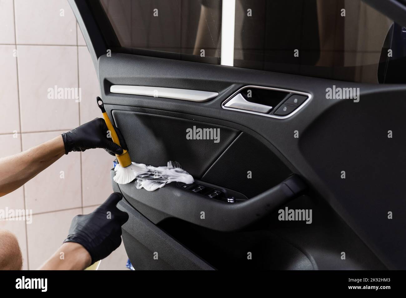 Process of foam and detergent cleaning with brush inside handle of car ...
