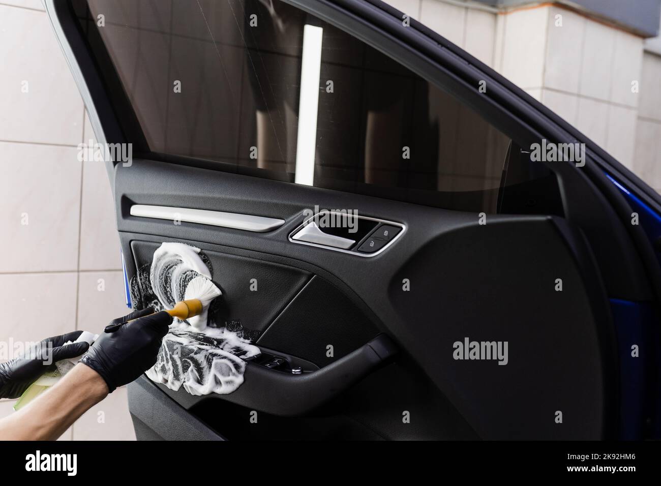 Process of foam and detergent cleaning with brush inside handle of car ...