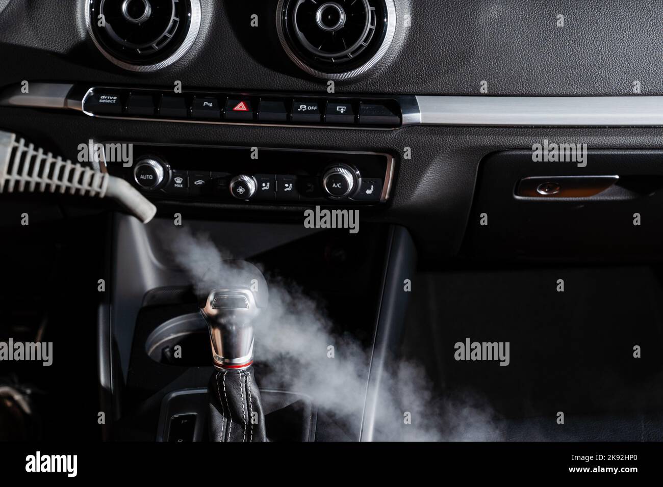 Steam cleaning of gearbox and dashboard in car. Vaping steam. Cleaning ...