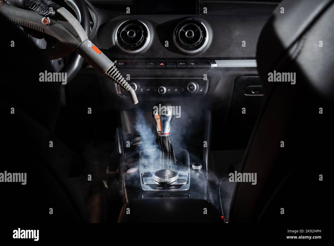 Steam cleaning of gearbox and dashboard in car. Vaping steam. Cleaning ...