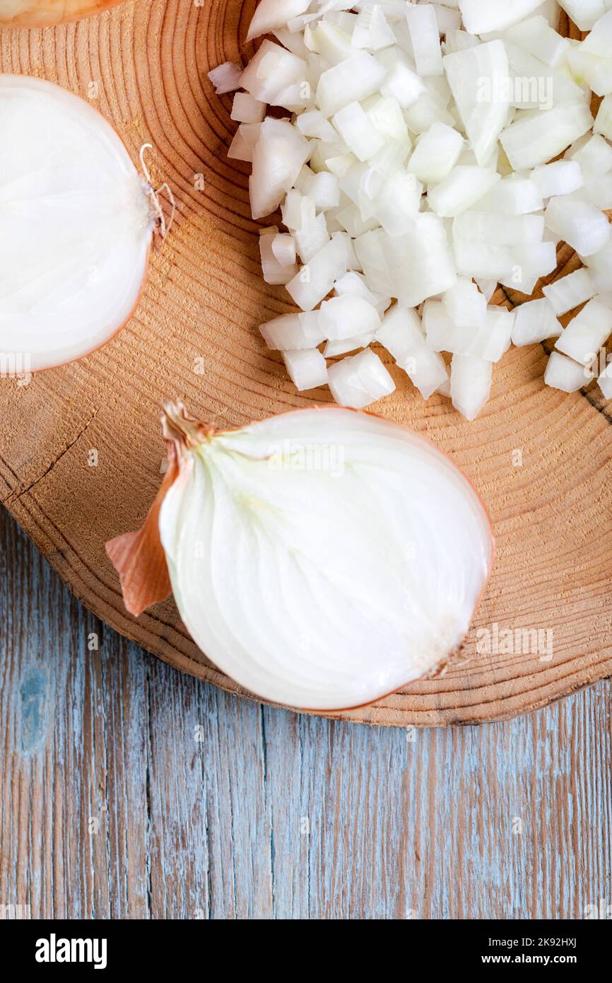onions cut in half and chopped on old wooden board Stock Photo - Alamy