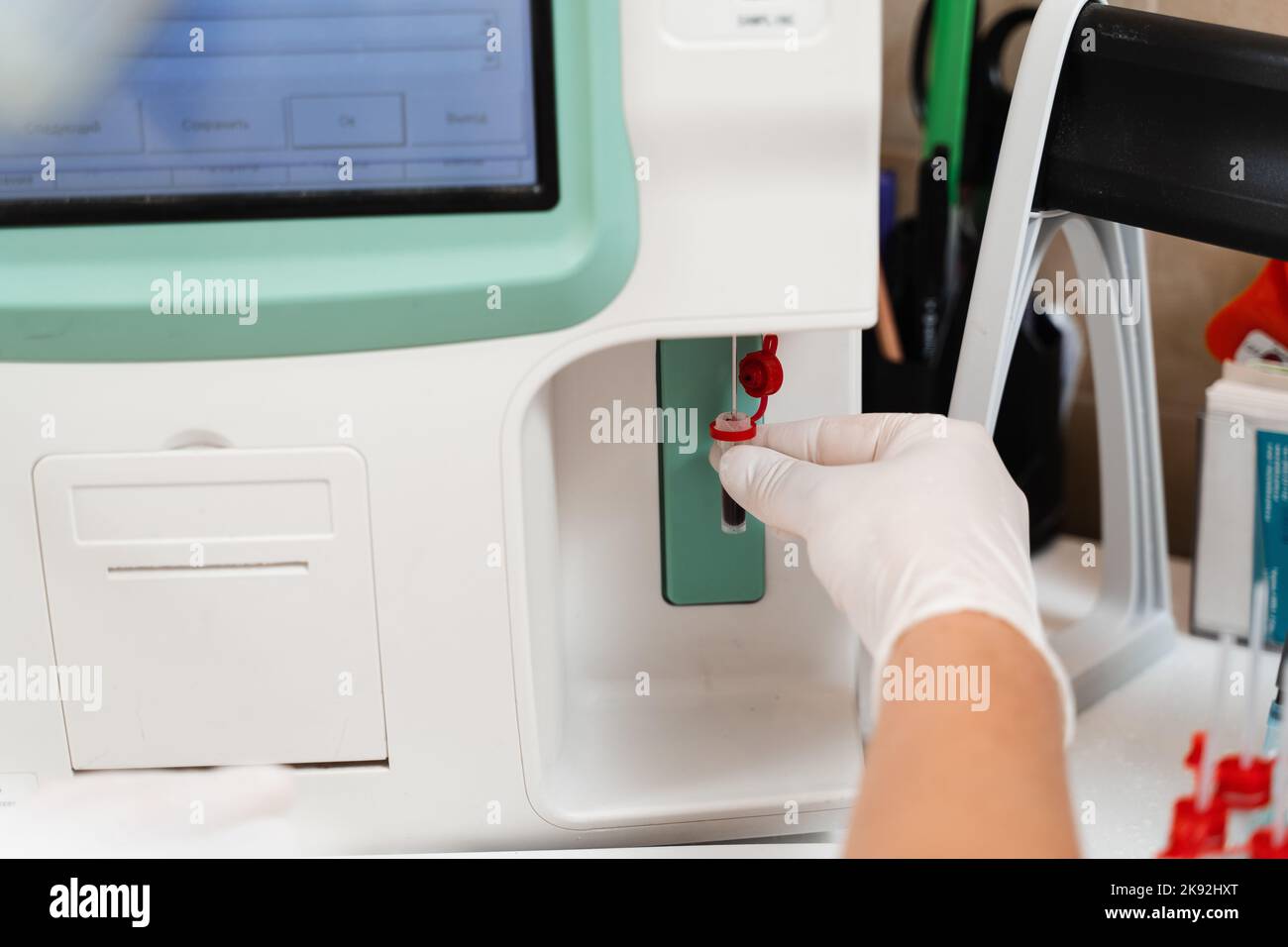 Blood analysis on analyzer in laboratory close-up. Laboratory assistant ...