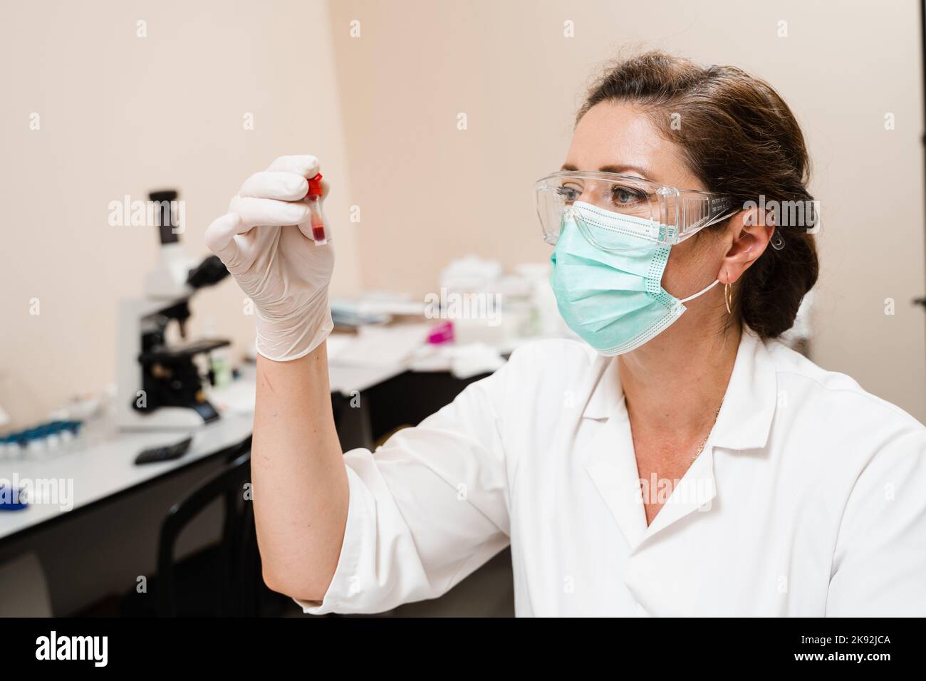 Doctor in mask looks glass hi-res stock photography and images - Alamy
