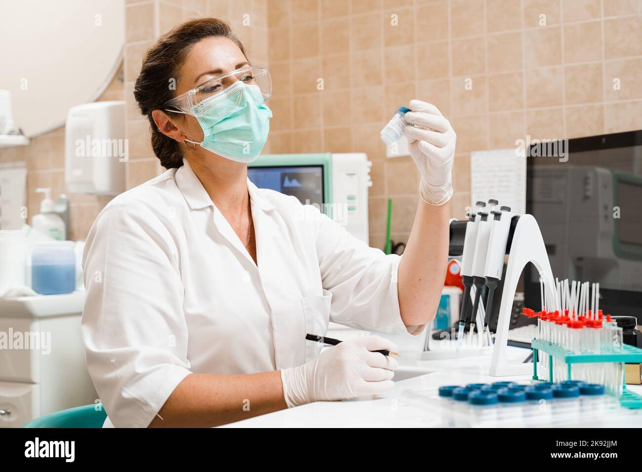 Laboratory assistant holds test tubes for gynecological and cytological ...