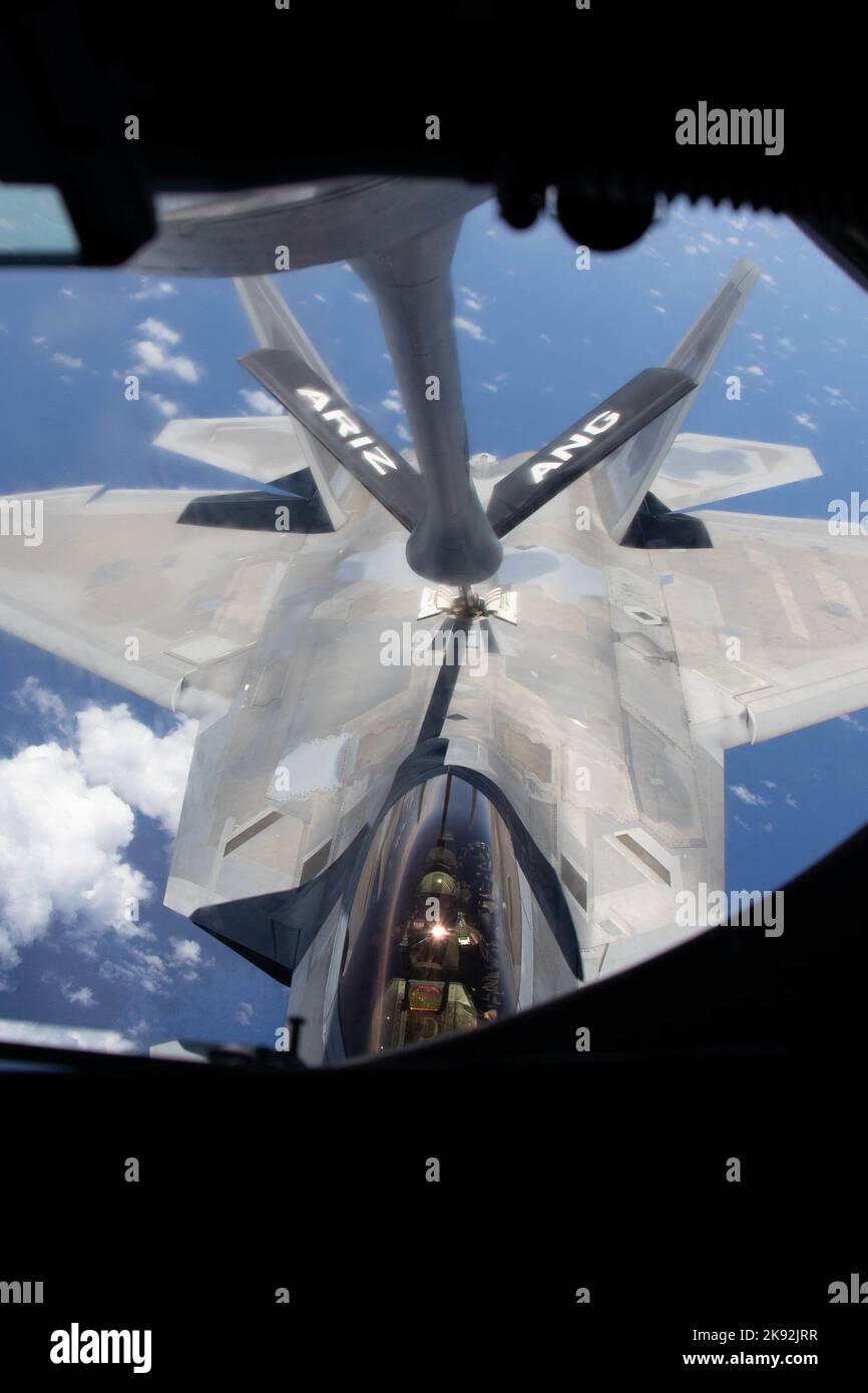 A U.S. Air Force F-22 Fighter pilot maneuvers their jet under a KC-135 ...