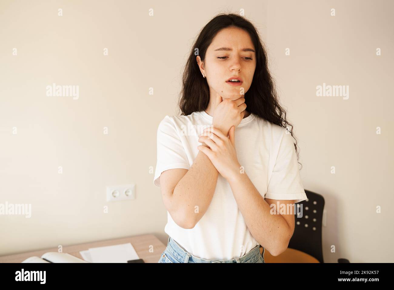 Pharyngitis first symptoms throat ache. Sick attractive girl touches ...