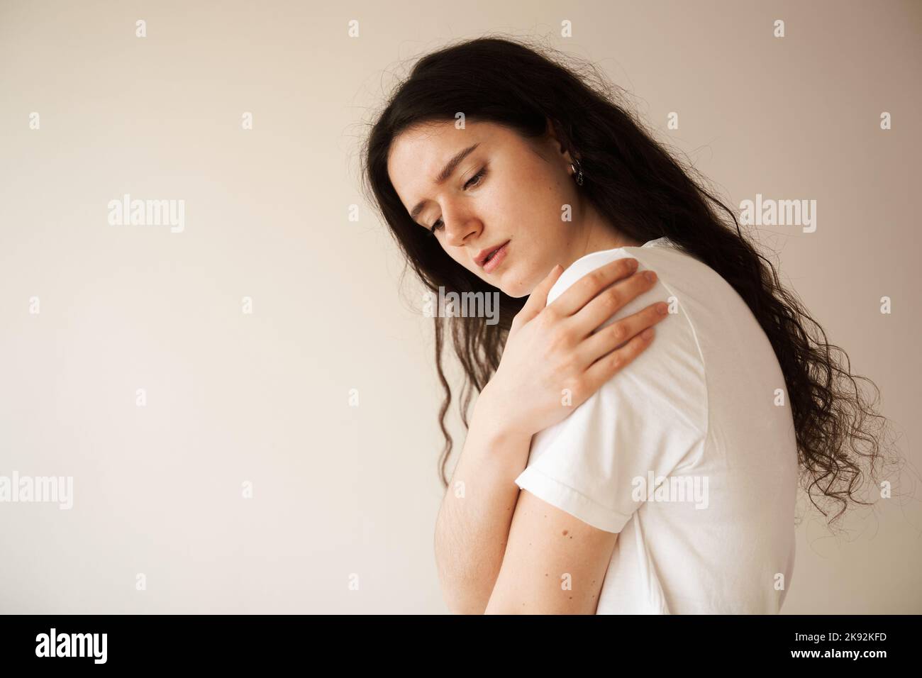 Shoulder injury. Beautiful girl with pain and bruise in her arm due to ...