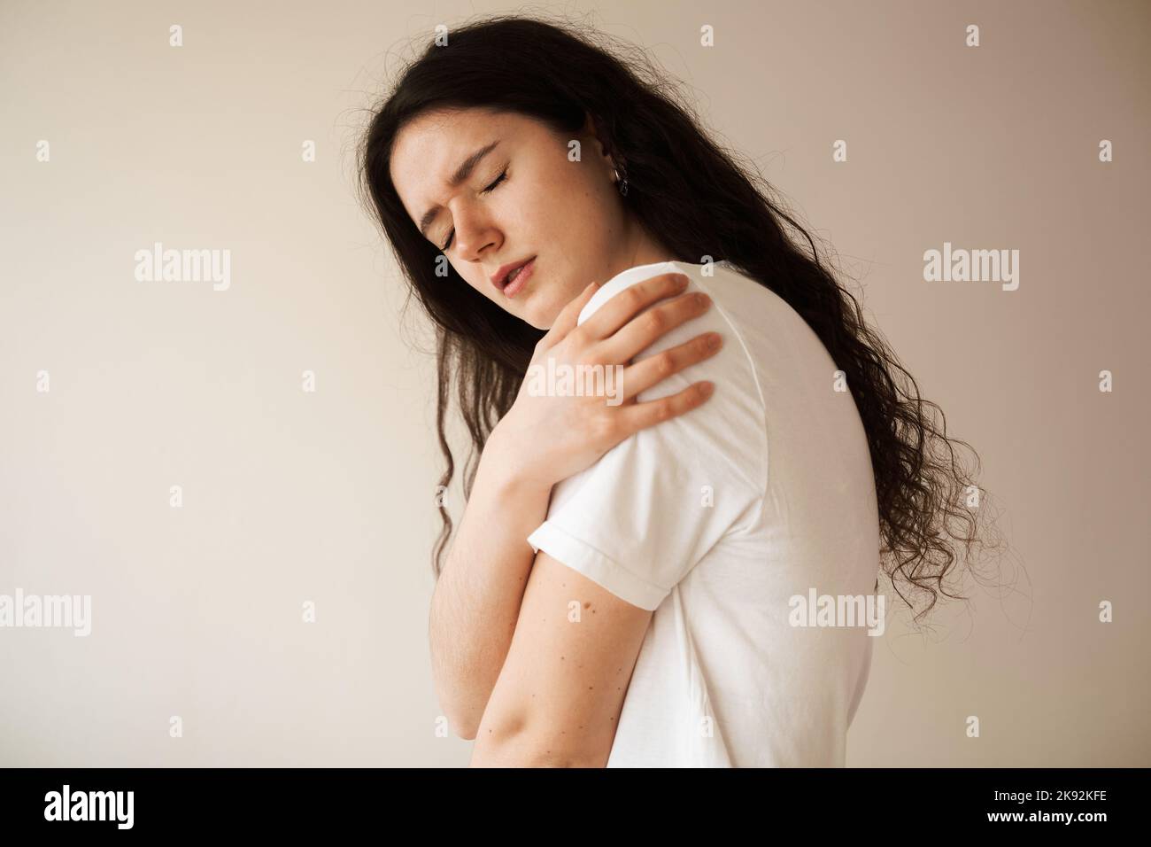 Shoulder injury. Beautiful girl with pain and bruise in her arm due to ...