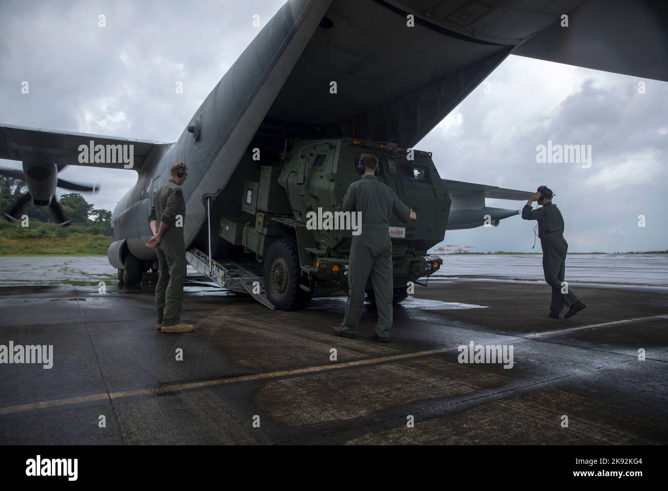 U.S. Marines with Marine Aerial Refueler Transport Squadron (VMGR) 152 load a High Mobility ...