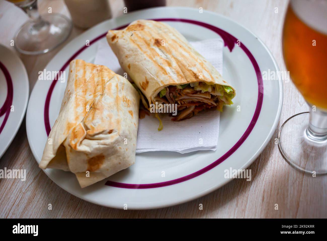 Cut tasty shawarma with chopped vegetables and greens Stock Photo - Alamy