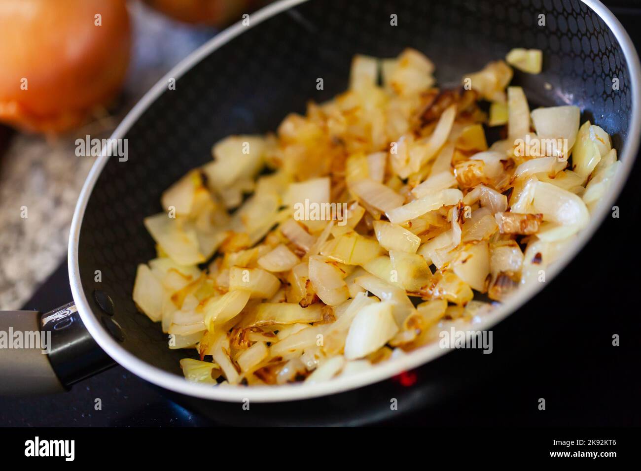 Fried onions in a frying pan Stock Photo - Alamy