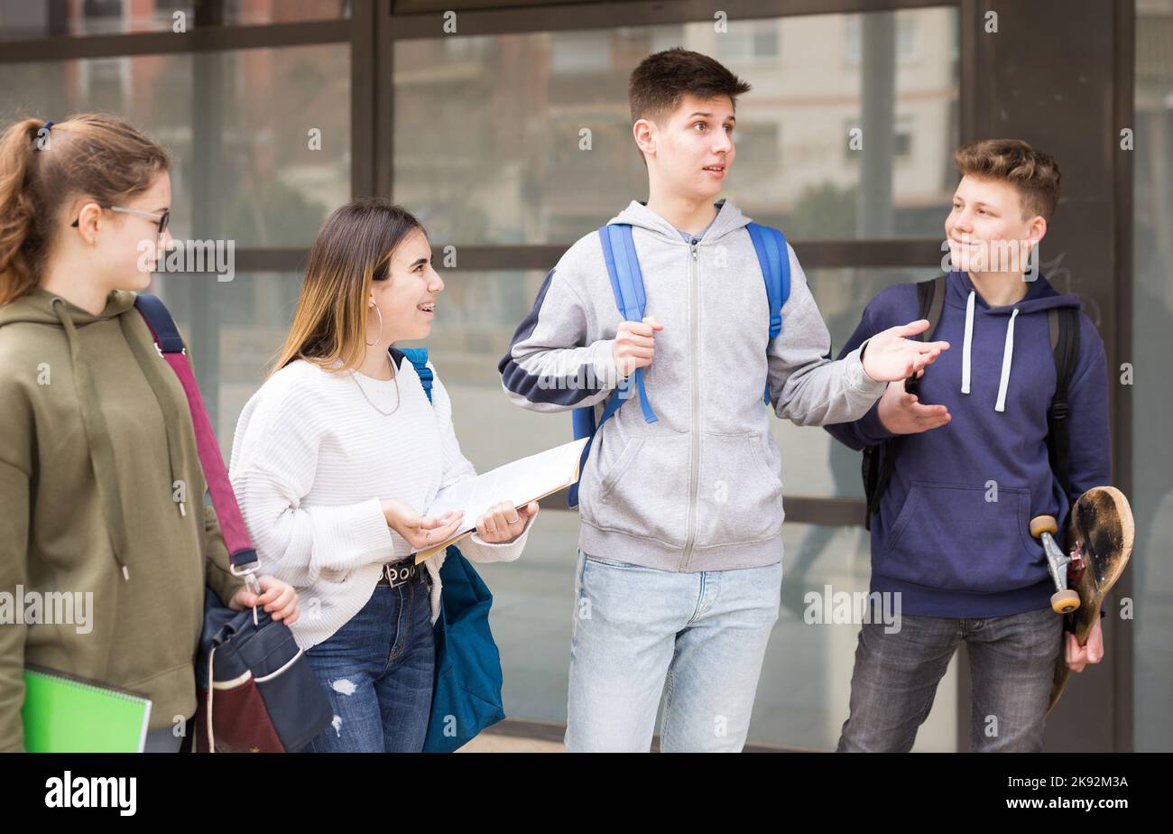 Carefree teen students walking outside school Stock Photo - Alamy