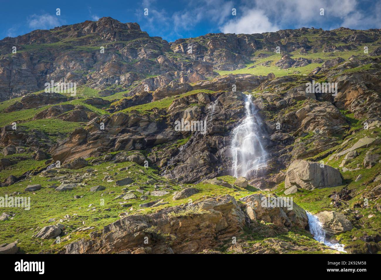 Waterfall at springtime in alpine landscape, Gran Paradiso Alps, Italy ...