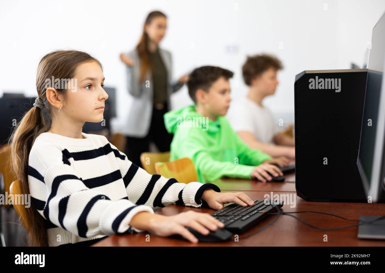 Schoolgirl using PC during computer science lesson Stock Photo - Alamy