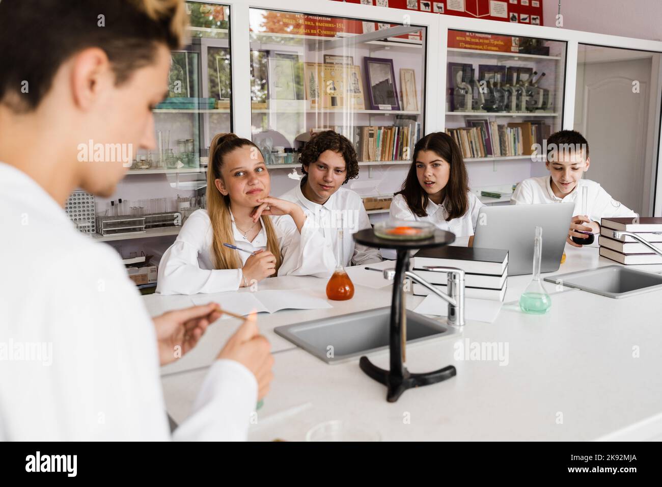 Experiment with fire. School chemistry teacher shows children ...