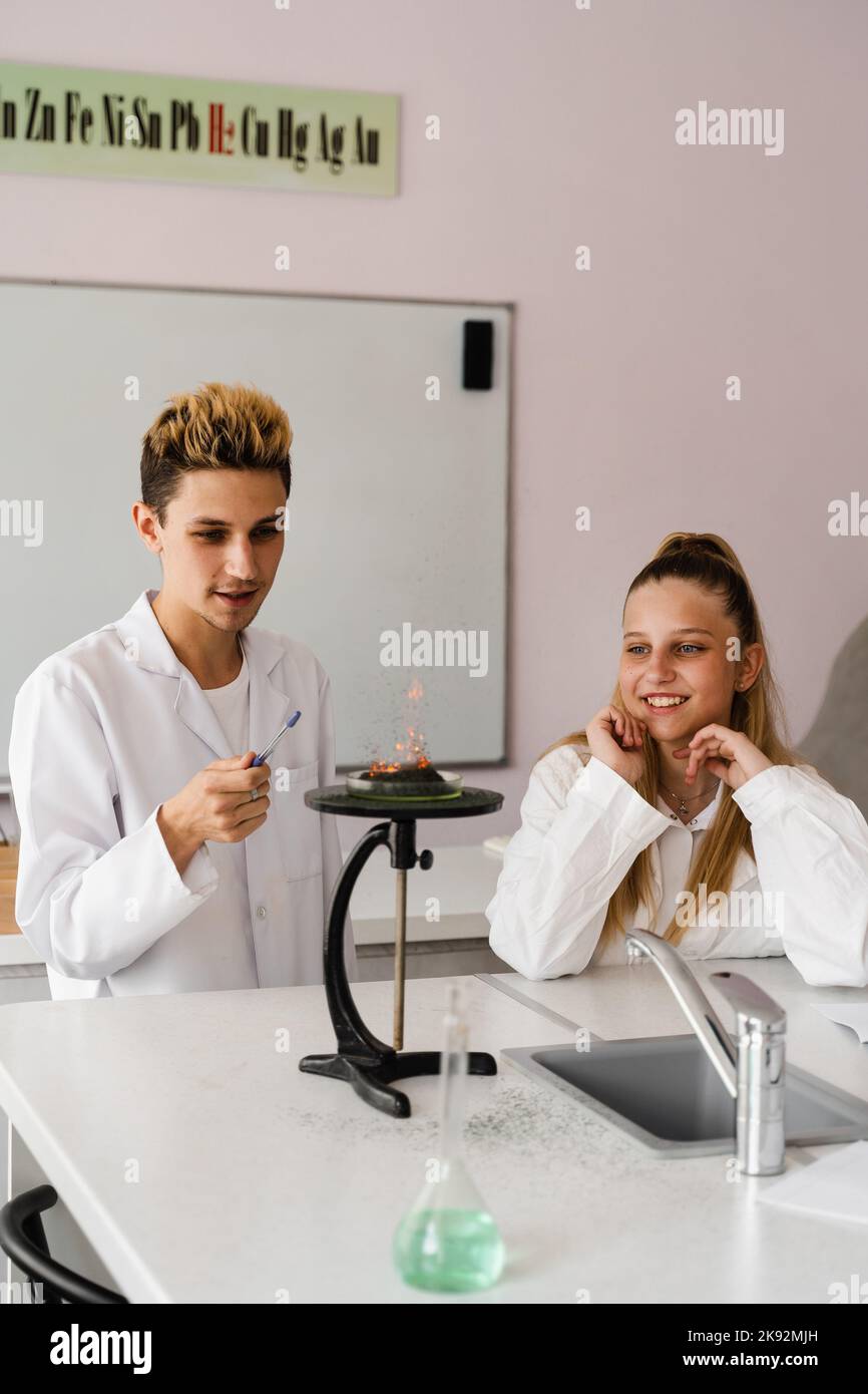Experiment with fire. School chemistry teacher shows children ...