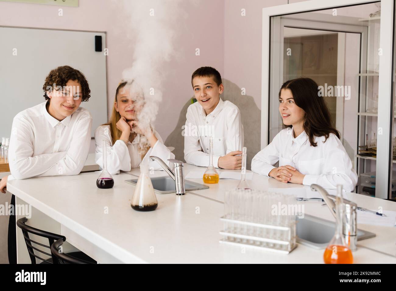 Volcano experiment. School chemistry teacher shows children experiments ...