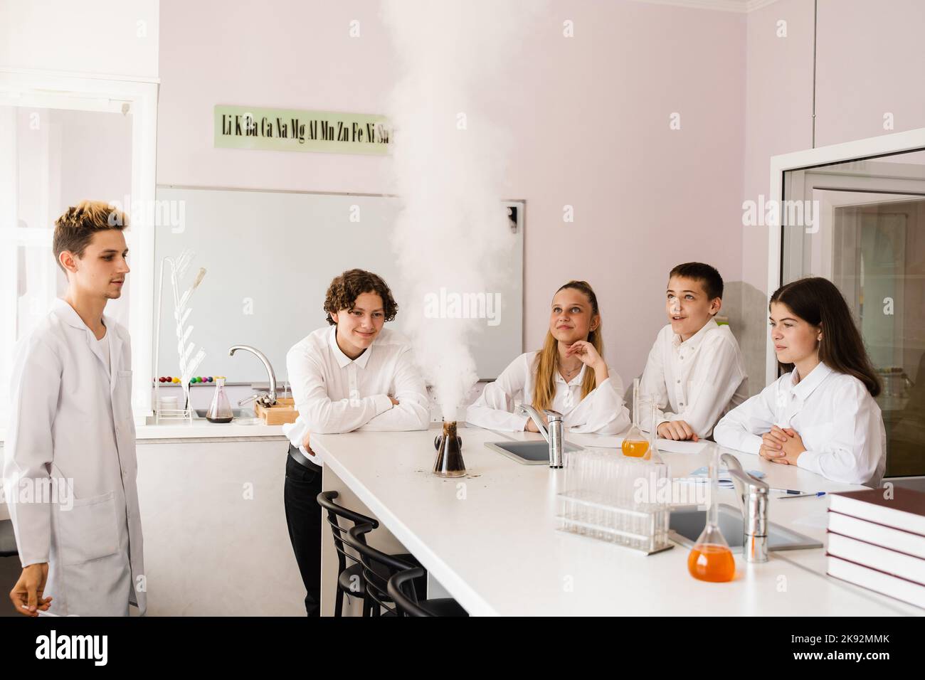 Volcano experiment. School chemistry teacher shows children experiments ...