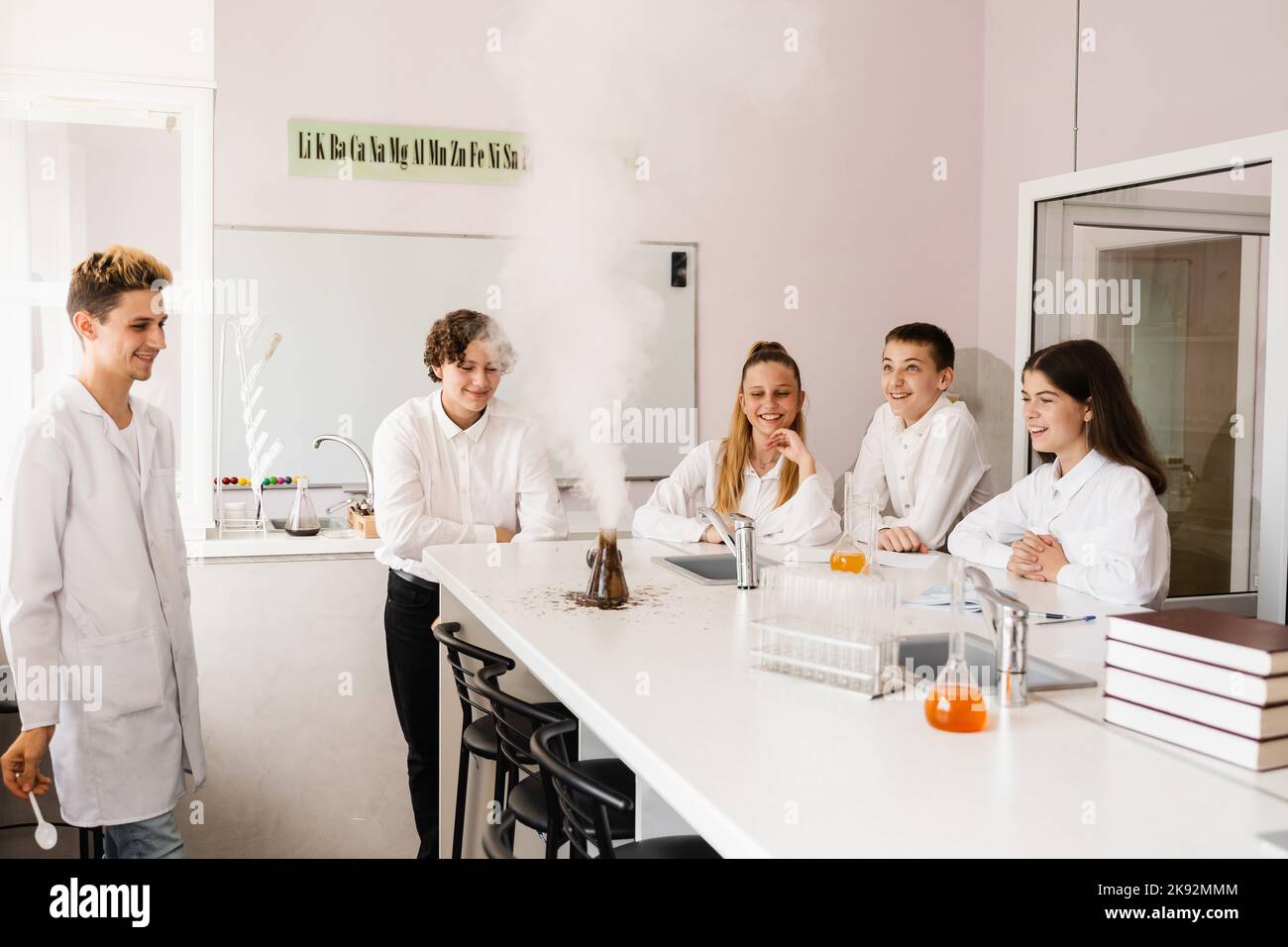 Volcano experiment. School chemistry teacher shows children experiments ...