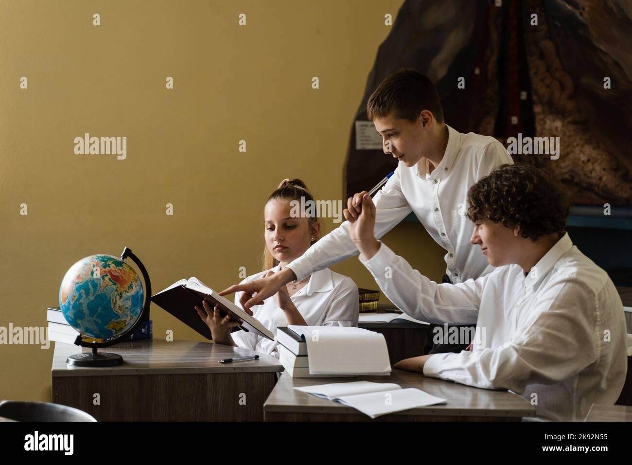 Pupils at school study and communicating with classmates at geography ...