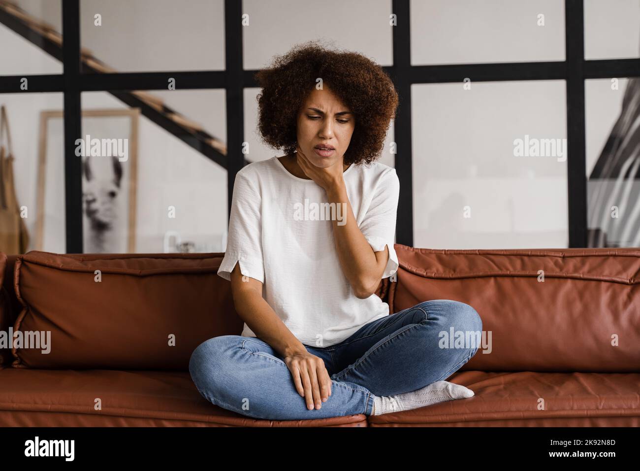 Sick african girl touches throat with pain. Laryngitis first symptoms ...