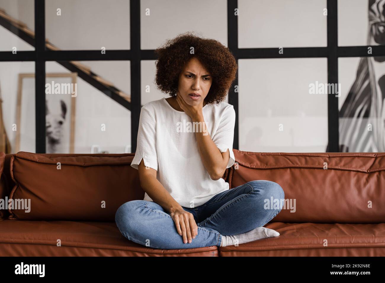 Sick african girl touches throat with pain. Laryngitis first symptoms ...