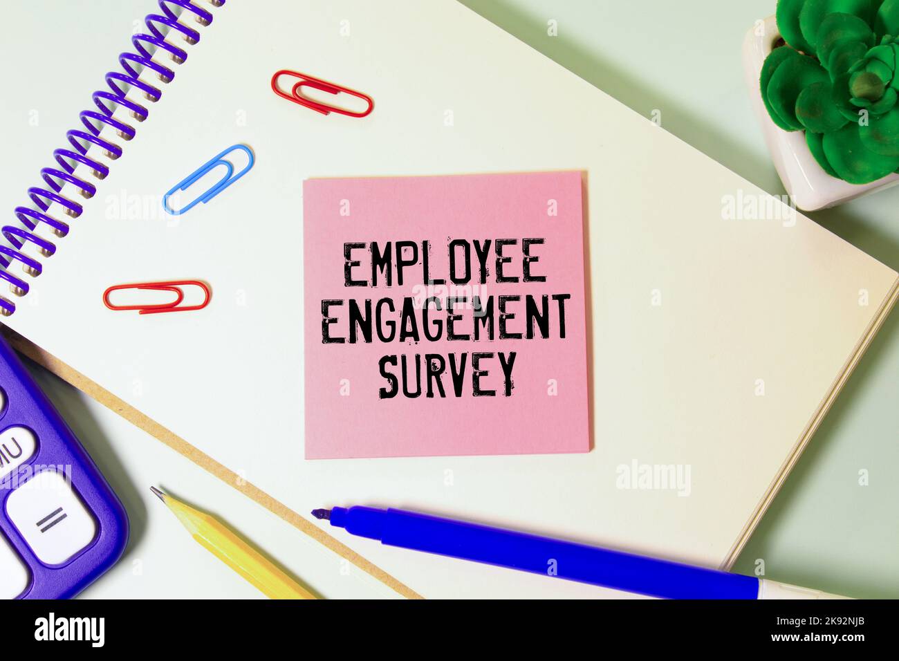 EMPLOYEE ENGAGEMENT SURVEY text written on white notebook with ...