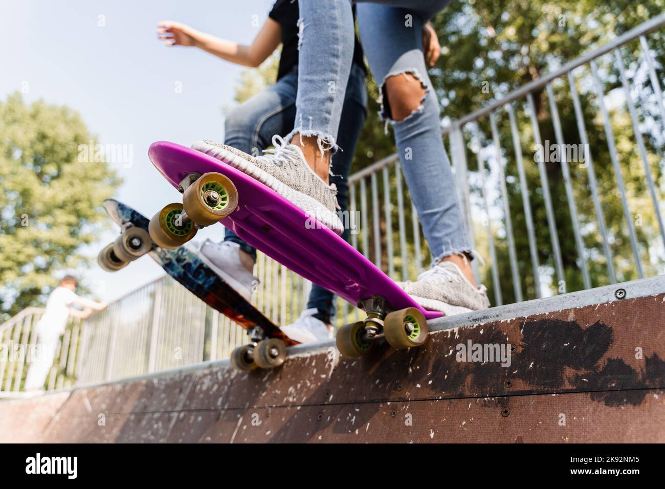 Children girls friends ready for ride on penny board on skateboard park ...