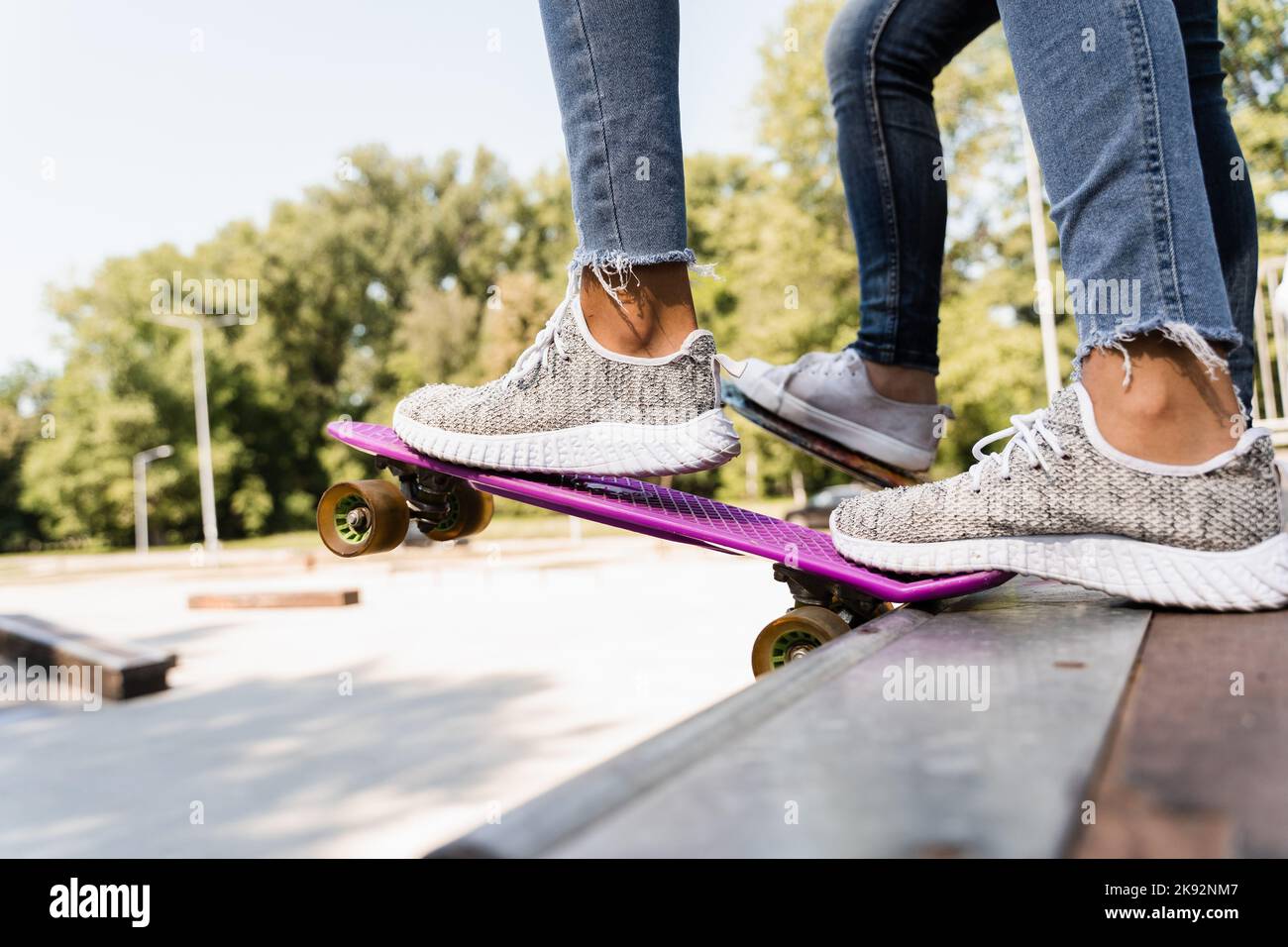 Children girls friends ready for ride on penny board on skateboard park ...