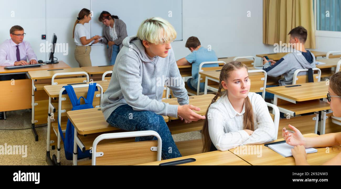 Teenage students talking during recess between lessons Stock Photo - Alamy