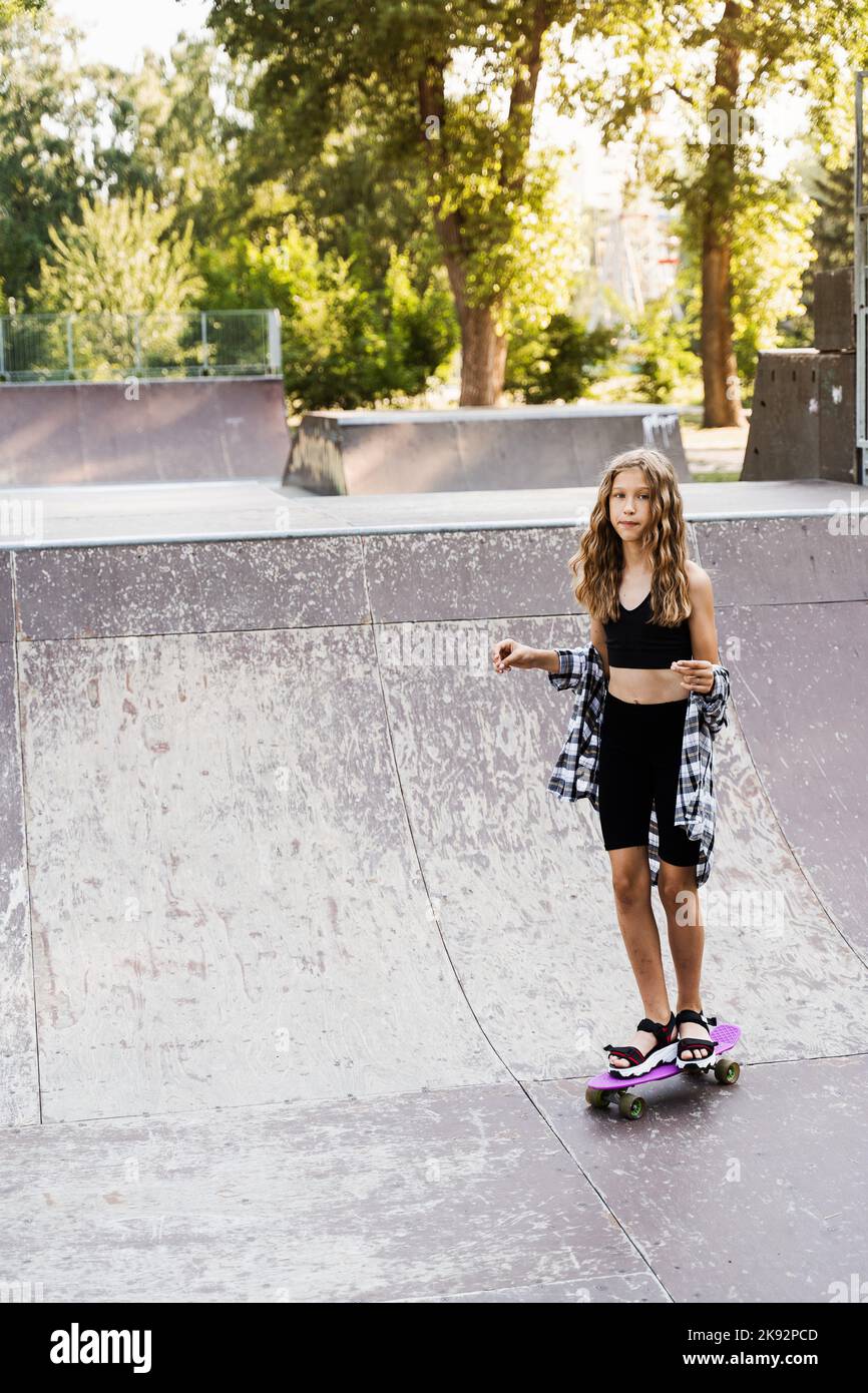 Child girl ride on penny board or skate board. Sports equipment for ...