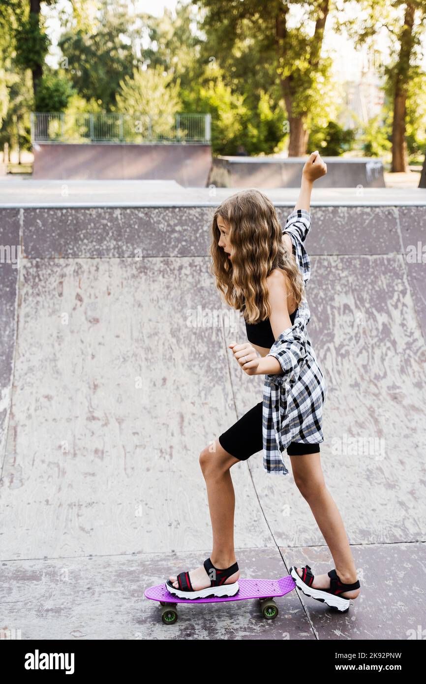 Child girl ride on penny board or skate board. Sports equipment for ...