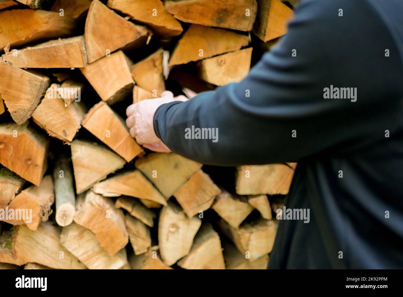 Firewood and mens hands close-up. solid fuel.Male hands pulling a log ...