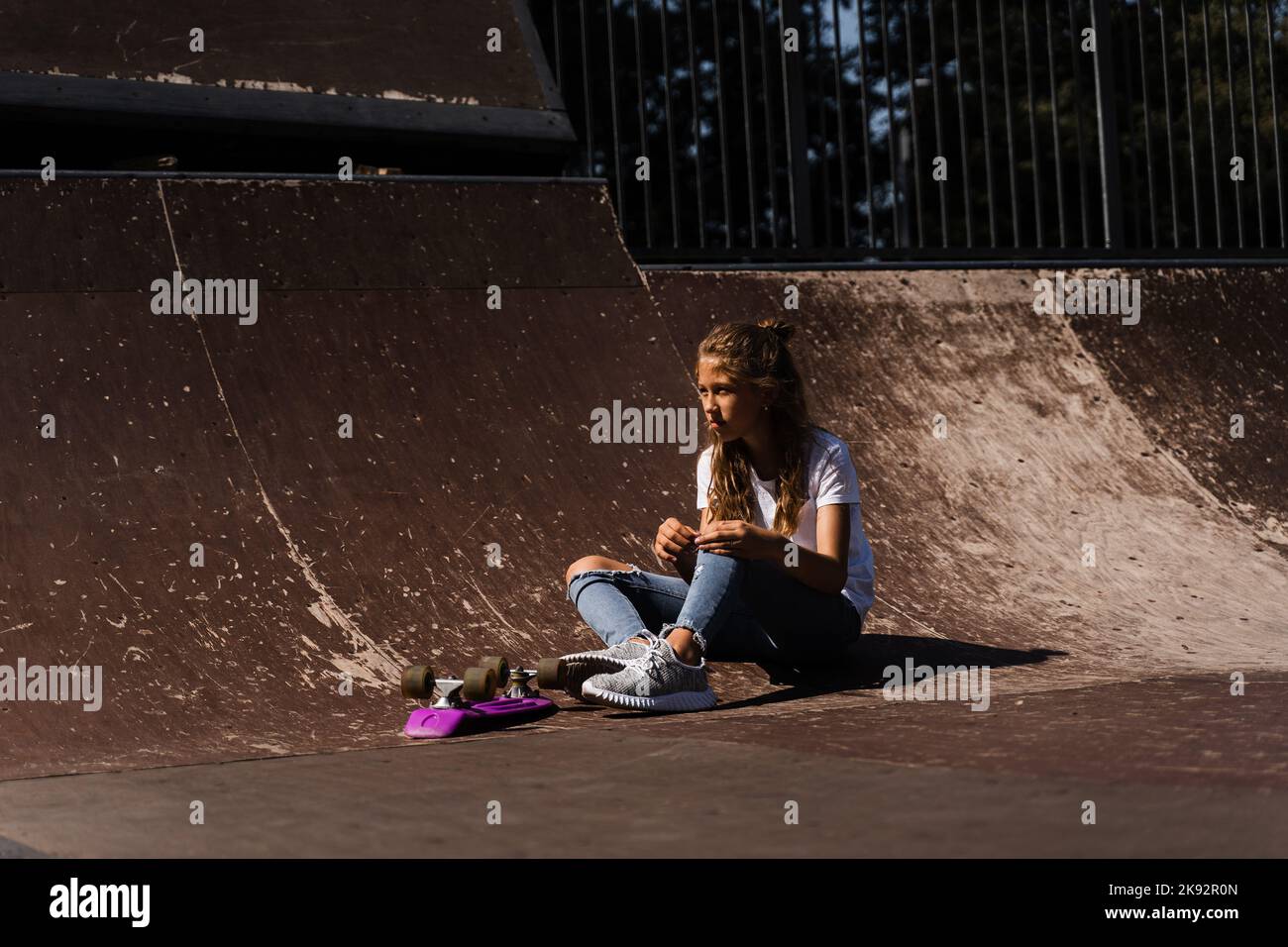 Active child girl after fall from penny board injured, sitting and feel ...
