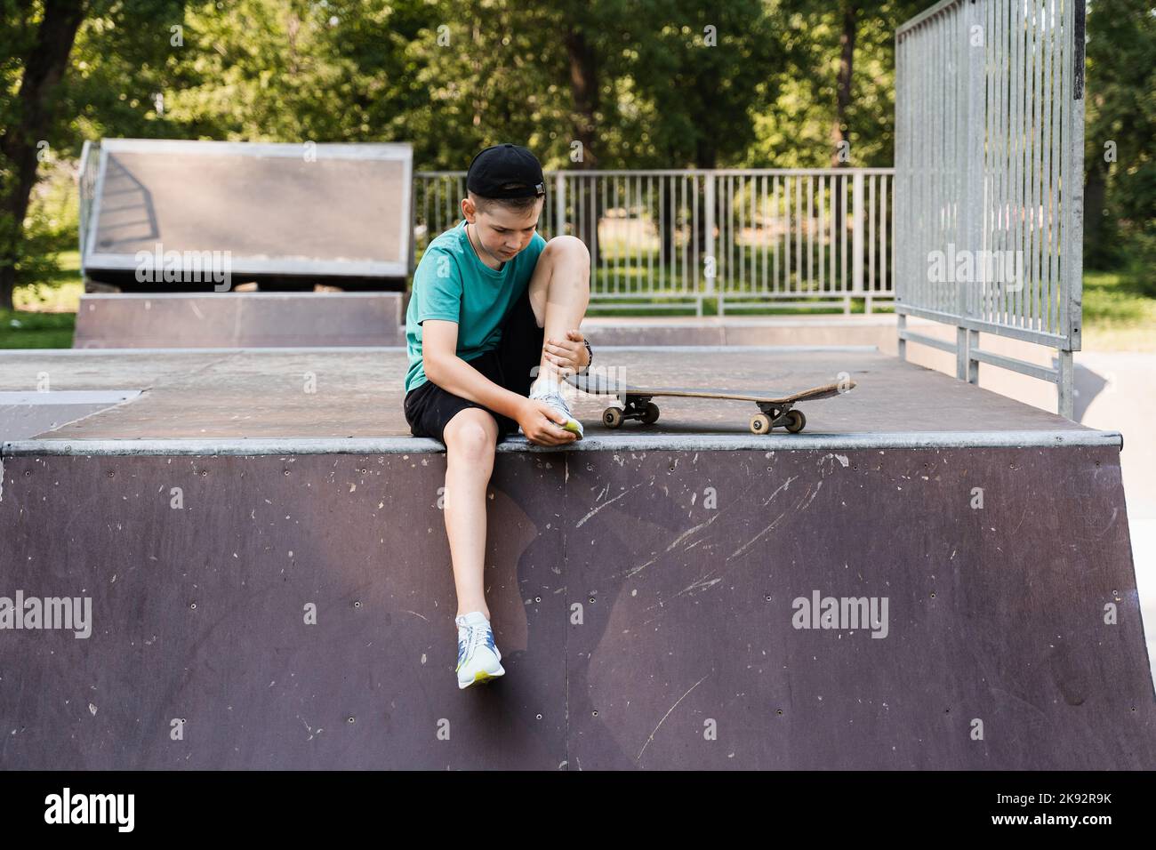 Leg and knee injury on skate board. Child traumatology. Child boy ...