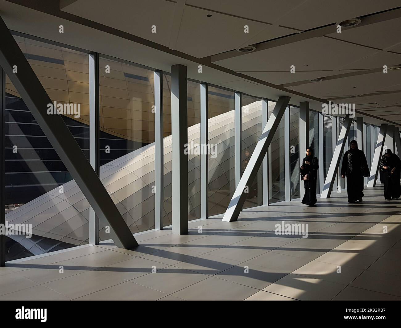 Three Arabic women wearing black Shaylas and Abayas walk through Dubai ...