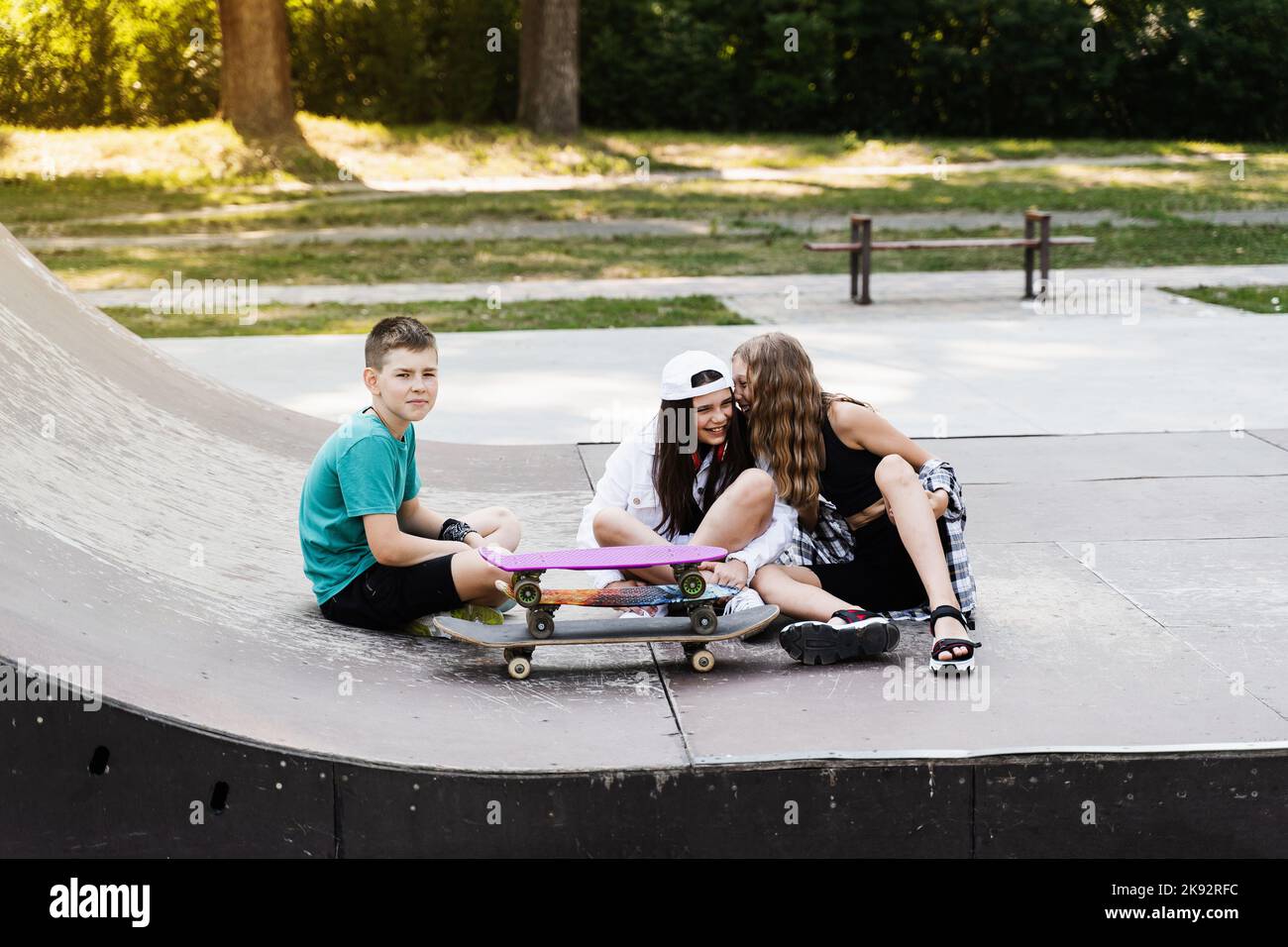 Children with skateboard and penny boards communicate and discuss on ...
