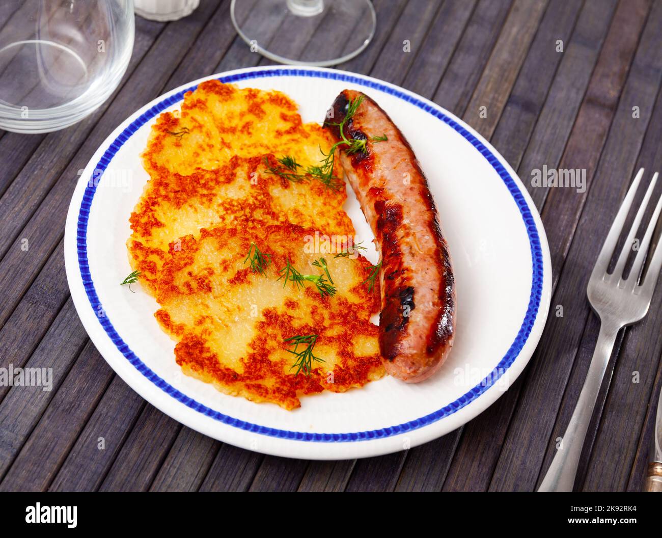 National dish of Belarusian cuisine is draniki with fried sausages ...