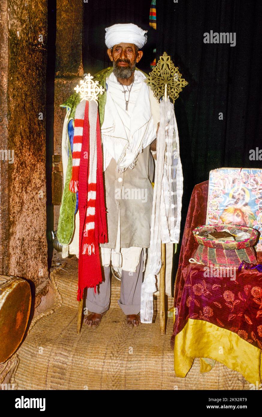 LALIBELA, ETHIOPIA - JUL 1, 1998: old coptic priest is proud to present ...